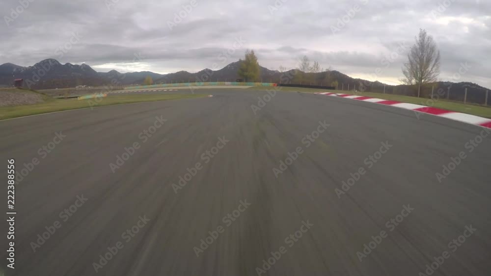 Stockvideo POV: Driving a fast car along the scenic asphalt racetrack ...