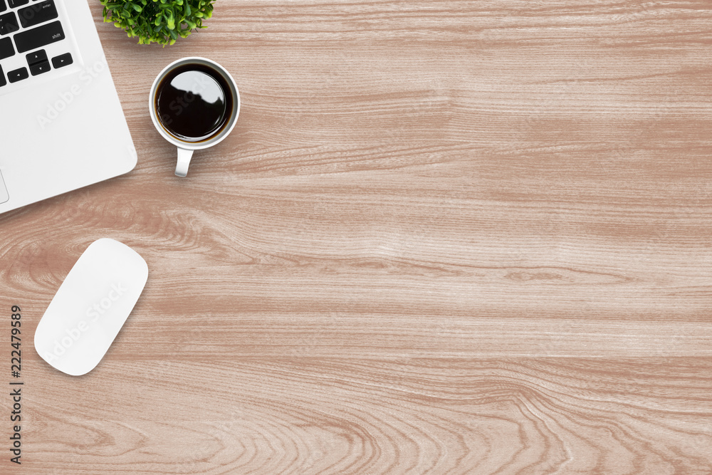 Wood office desk table with laptop computer, cup of coffee and supplies ...