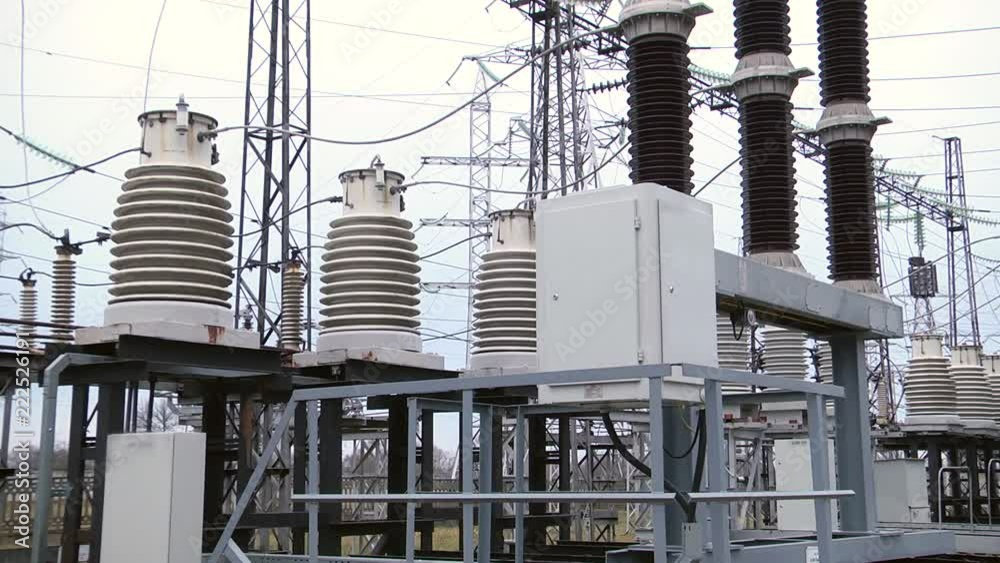 Air high-voltage switches. Electrical poles with wires and insulators ...