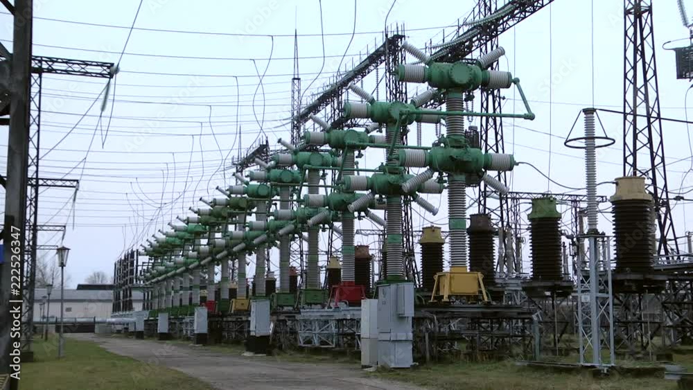 Air high-voltage switches. Electrical poles with wires and insulators ...