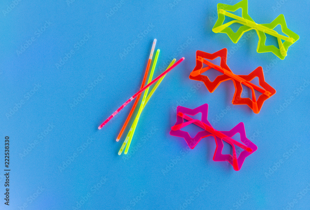 Neon Party supplies on blue background - Photo booth Props. Copy Space ...