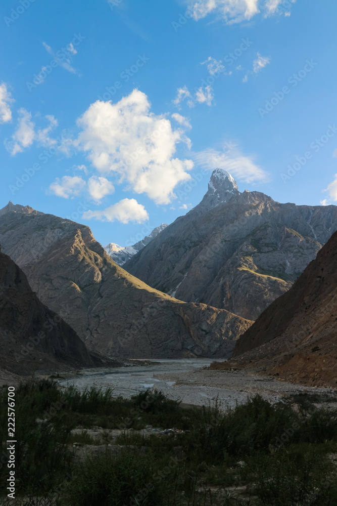 Oasis of green trees on the way to K2 base camp, Trekking along in the ...