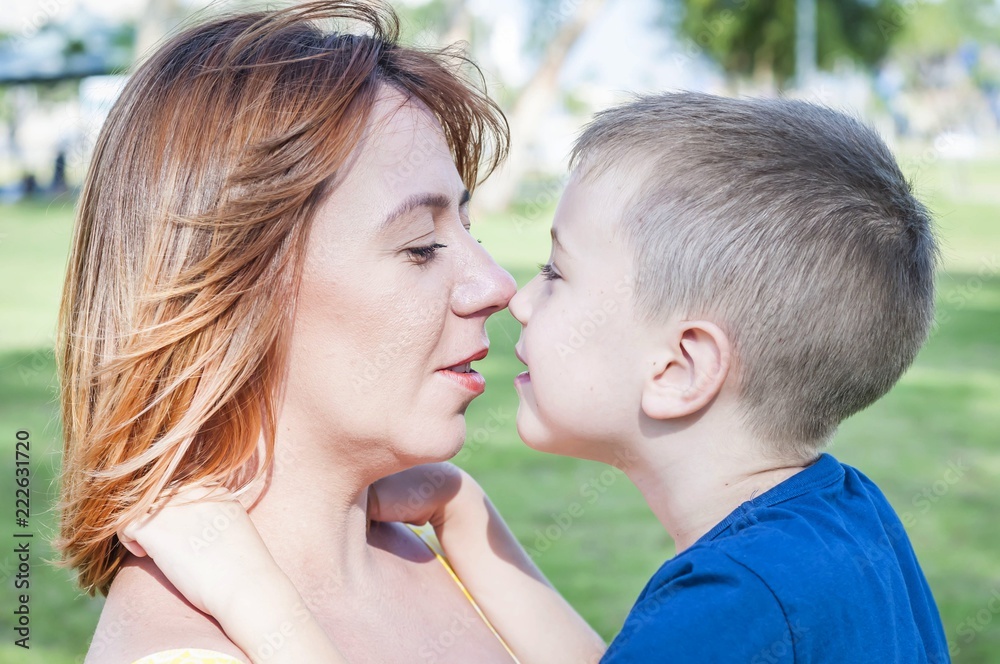 Young and beautiful Caucasian woman looking at her son, face to face ...