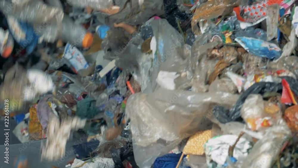 Sorting process at a modern factory. Lots of garbage sorted in a big ...