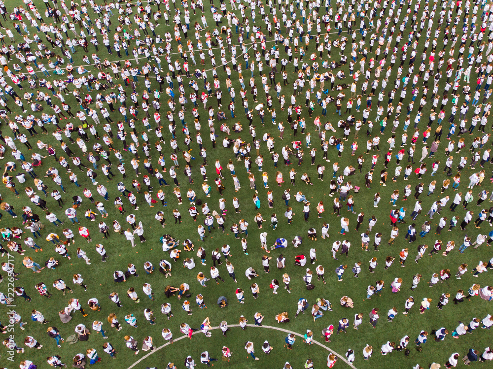 Top view drone of crowd of people on sports stadium football green lawn ...