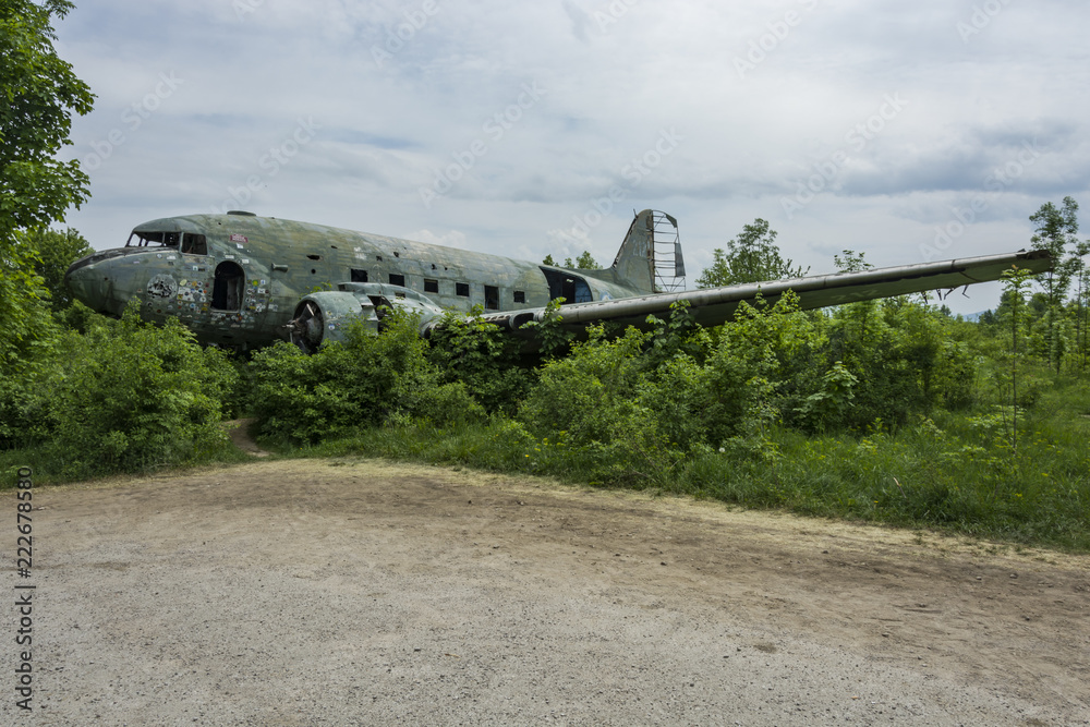 Old dirty broken ruined abandoned airplane among trees. An old wrecked ...