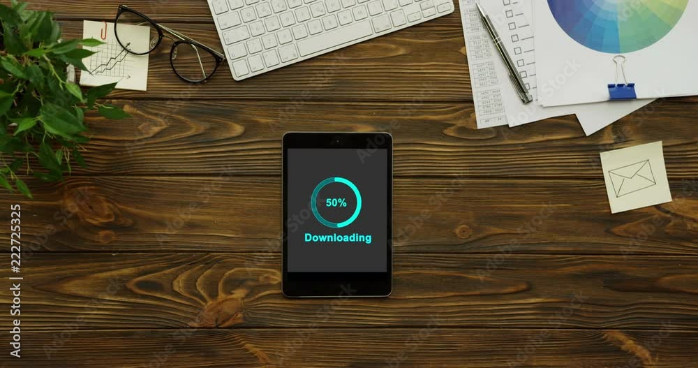 Blue circle of percents loading in the black screen of the black tablet ...