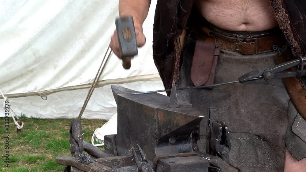 Ancient blacksmith's work at a medieval festival, the blacksmith ...