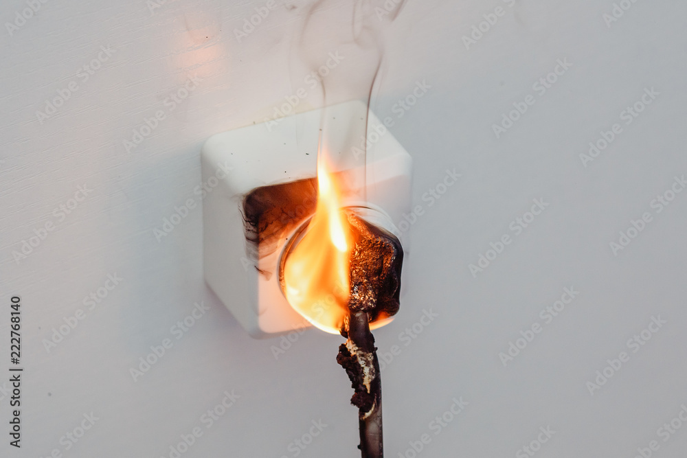 Fire and smoke in electrical outlet. Short circuit house wiring. Stock ...