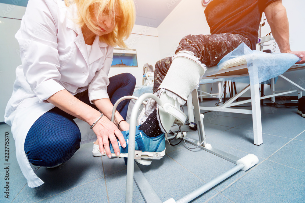 Patient on CPM (continuous passive range of motion) machines. Device to ...