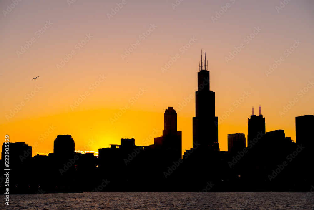 Chicago skyline picture during beautiful orange yellow sun as it lowers ...