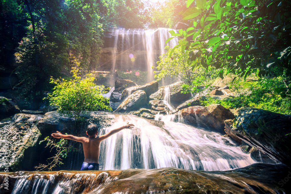 Boy playing waterfall in the forest at Soo Da Cave Roi et Thailand ...
