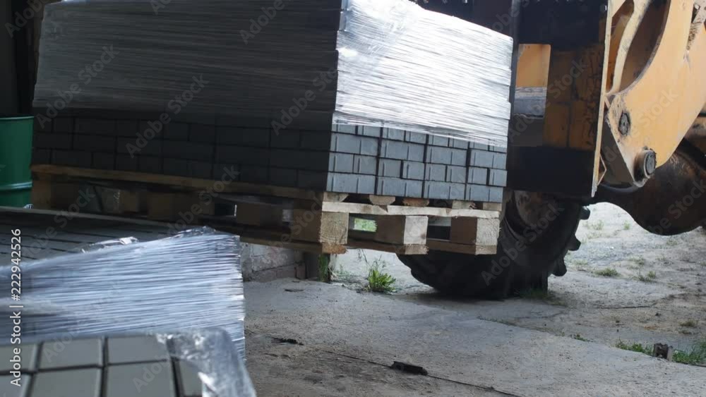 Loader machine loads finished interlocking concrete pavers Stock Video ...