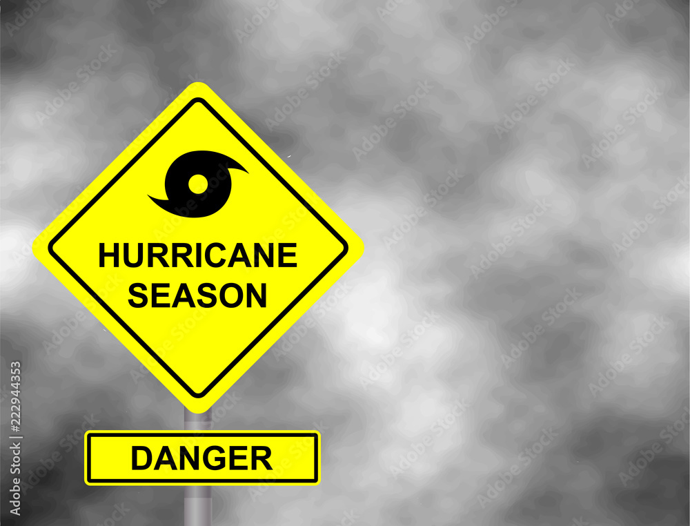 Hurricane sign road. Yellow hazard warning sign against grey sky ...