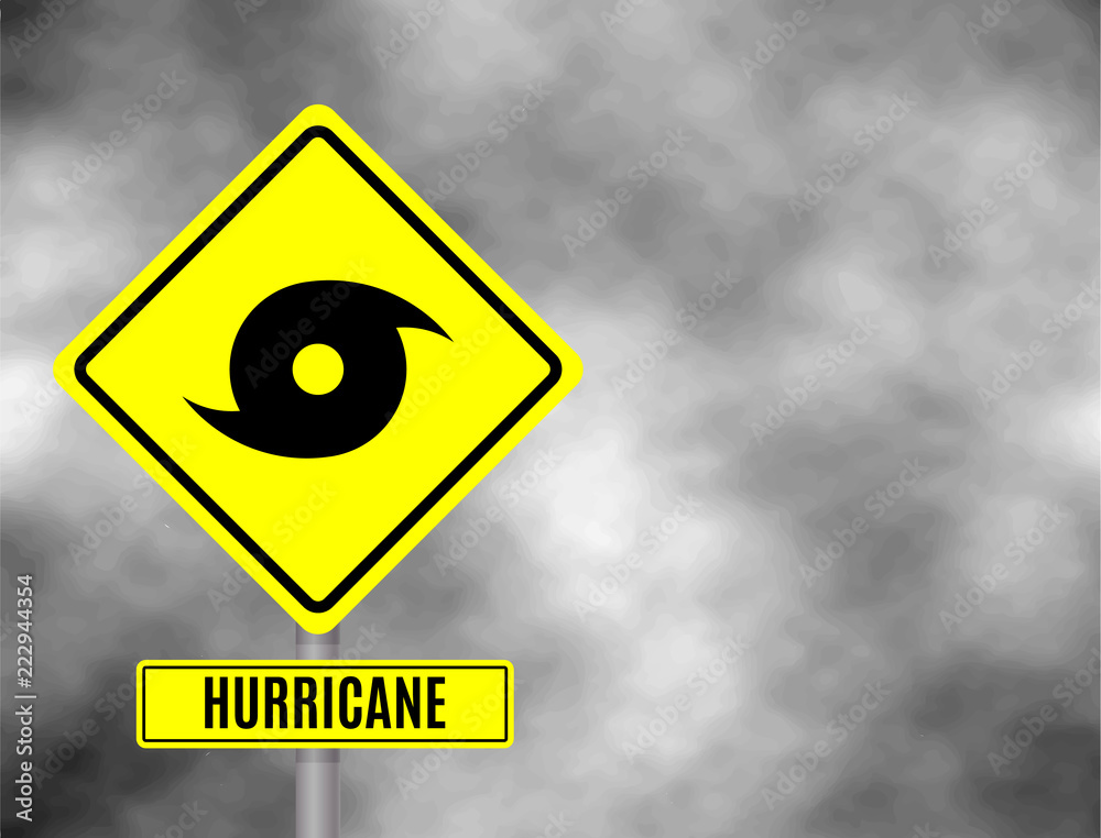 Hurricane sign road. Yellow hazard warning sign against grey sky ...