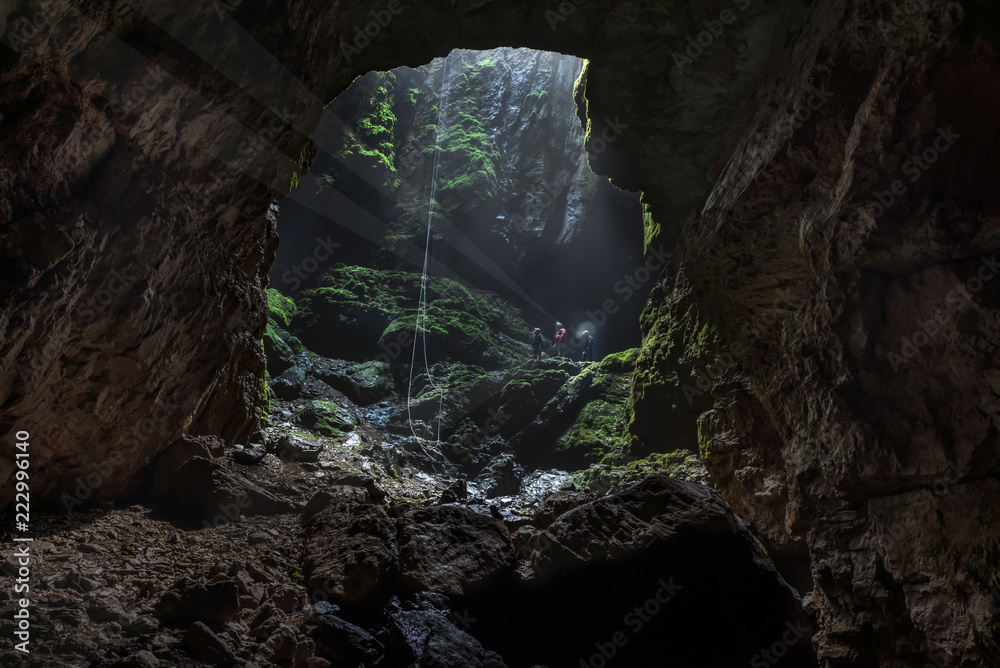 cave landing with rope and adventurous cave team Stock Photo | Adobe Stock