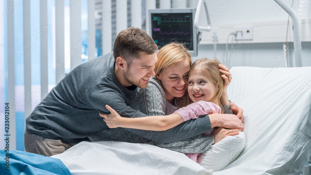 Portrait Shot of Happy Parents Hug Cute Little Girl Lying in the ...