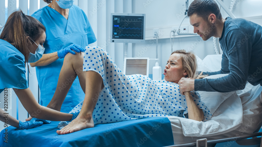 In the Hospital, Woman in Labor Gives Birth, Obstetricians and Doctors ...