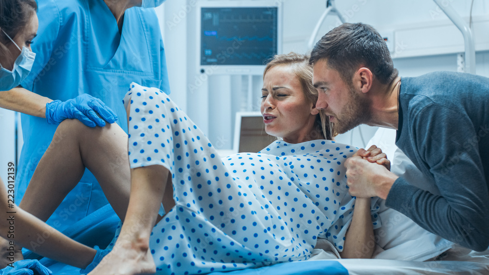In the Hospital, Woman in Labor Pushes to Give Birth, Obstetricians and ...
