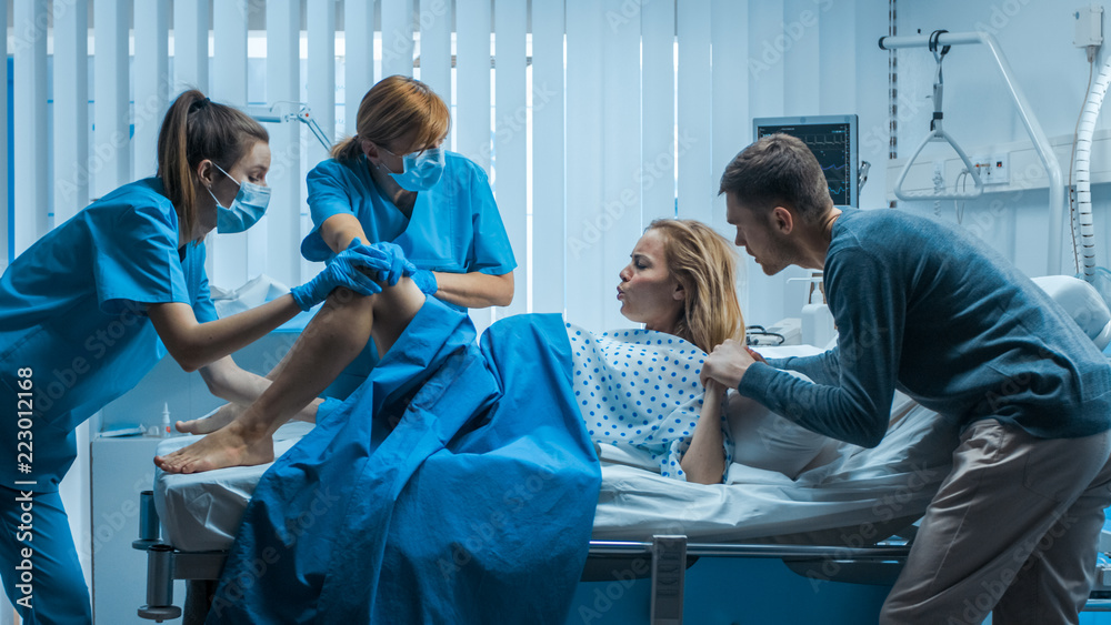 In the Hospital Woman in Labor Pushes to Give Birth, Obstetricians ...