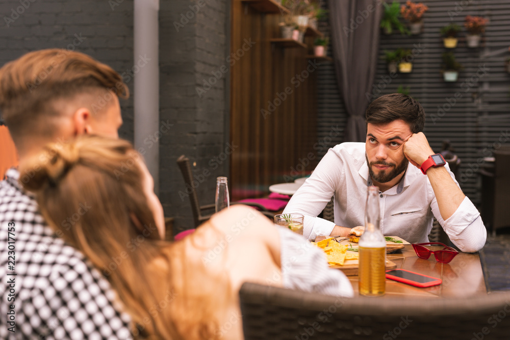 Bored best friend. Sad young ma leaning his head on his hand and ...