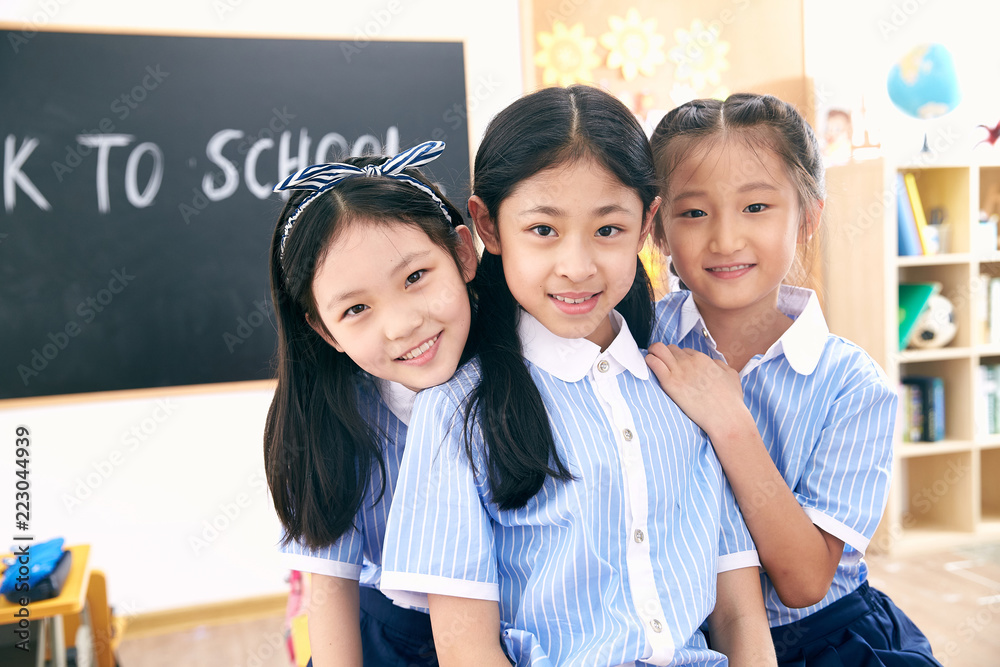 Cute little girls in the classroom Stock Photo | Adobe Stock