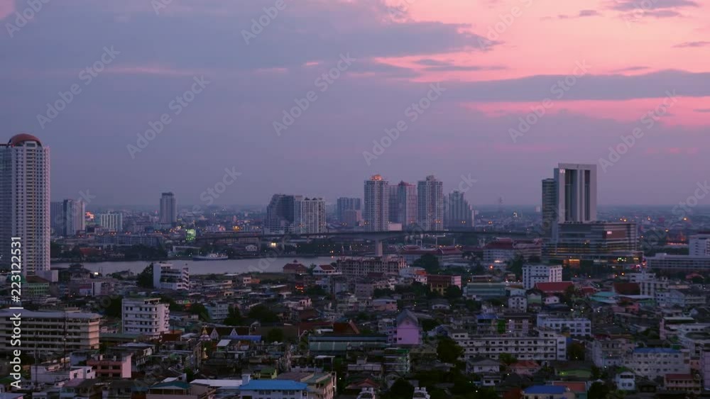 Zooming out panoramic view of Bangkok at dusk. Fantastic cityscape with ...