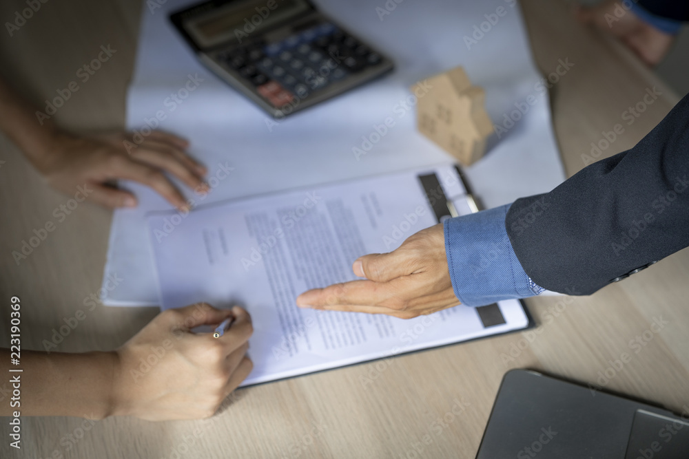 Owner of home signing contract after architect build home finish ...