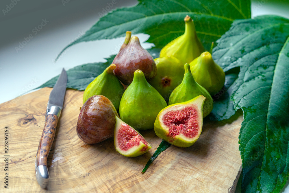 Fruits of fig tree with leaves on white background/ Fresh figs with ...