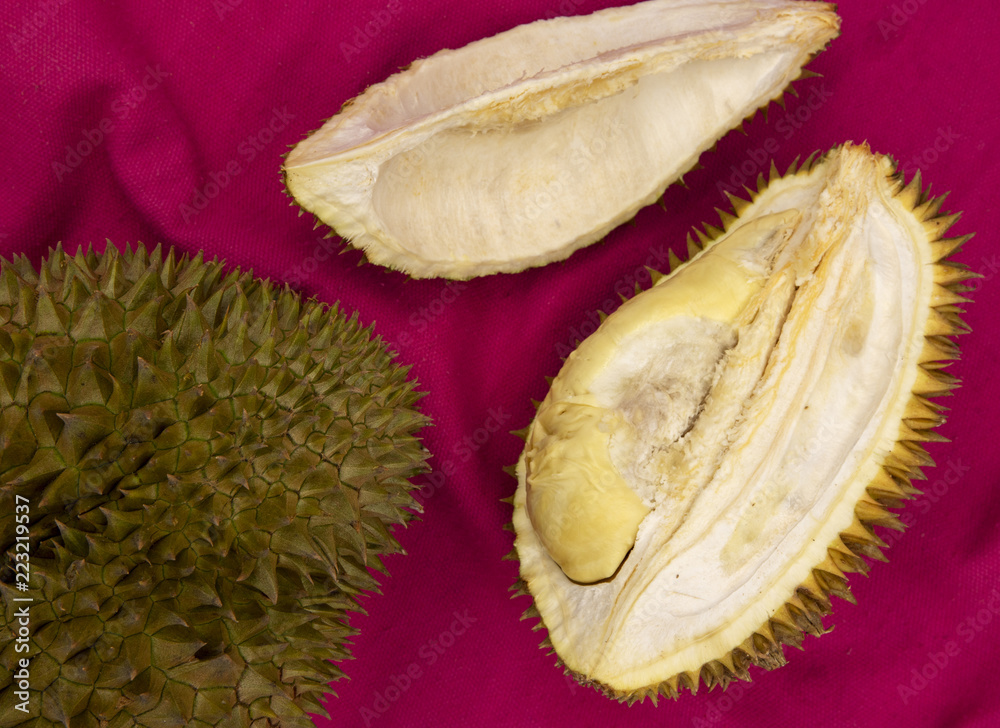 Tropical fruit durian on red background. Whole and cut durian flat lay ...