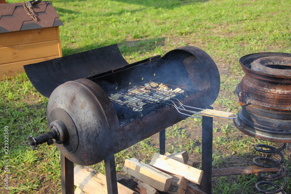 Homemade barbecue grill with gas cylinder in the summer on a country ...