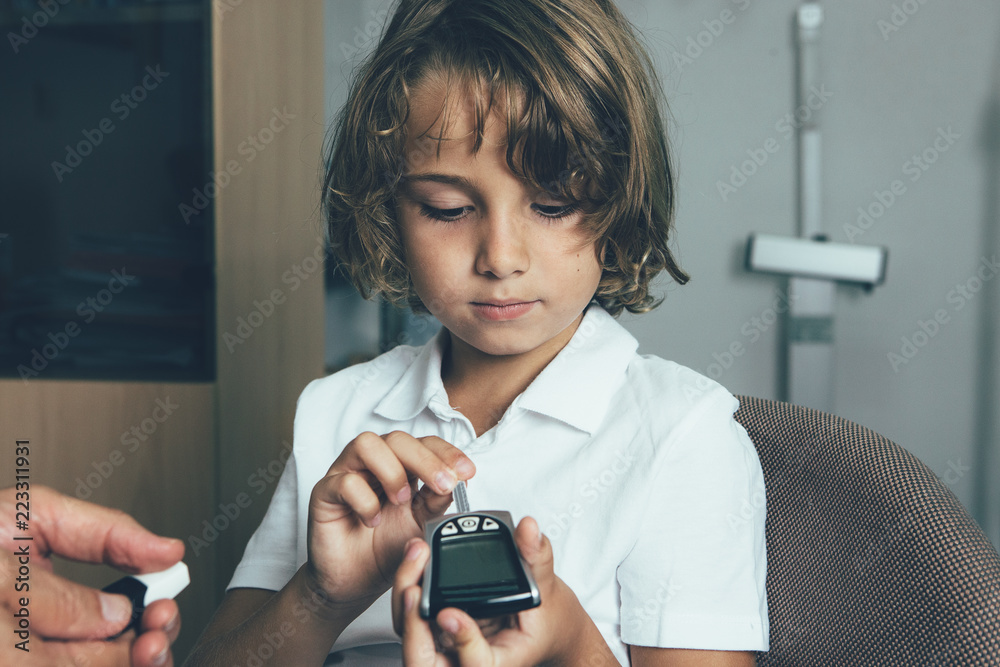 Child using a glucometer Stock Photo | Adobe Stock