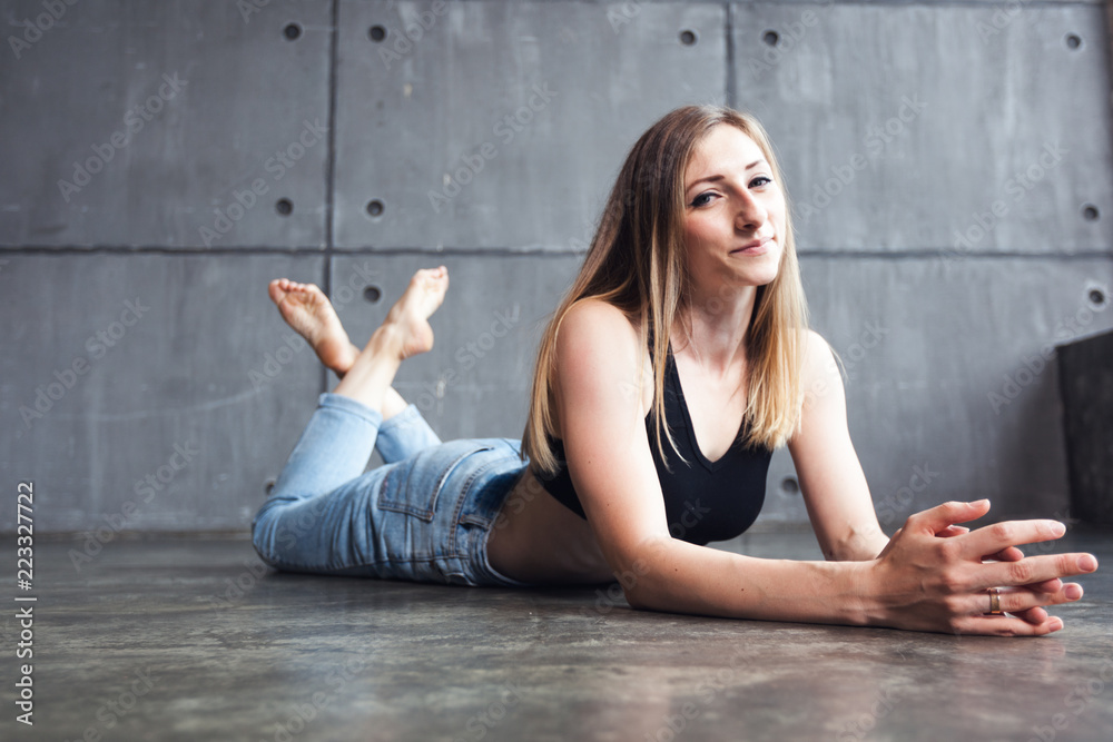 young beautiful woman professional dancer lies on the floor after ...