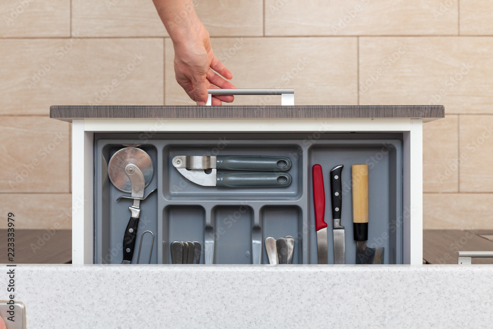 High angle top view photo of woman hand open kitchen drawer by door ...
