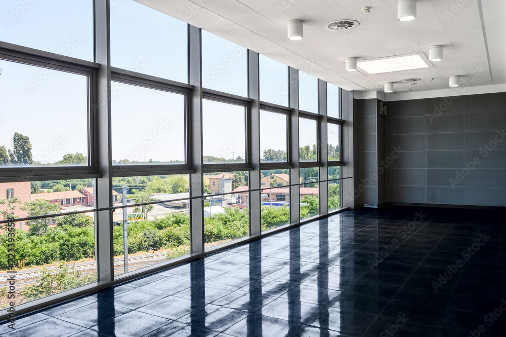 Big empty office space with window wall. Day light illumination. Grey ...