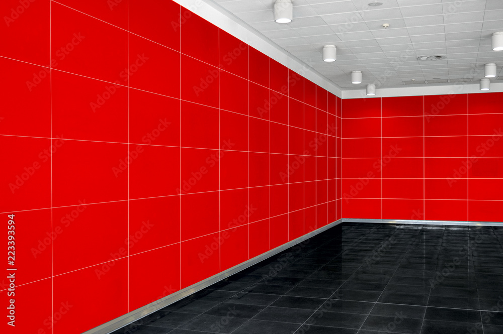 Big empty room interior with bright red wall, whire ceiling and dark ...