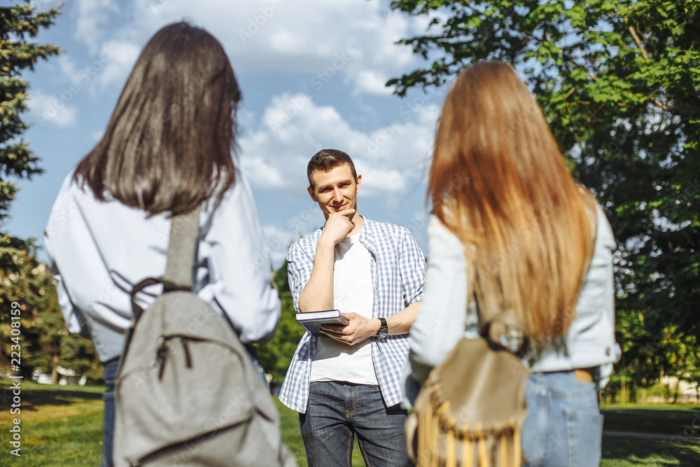 Young attractive guy making a choice between two girls. Love triangle ...