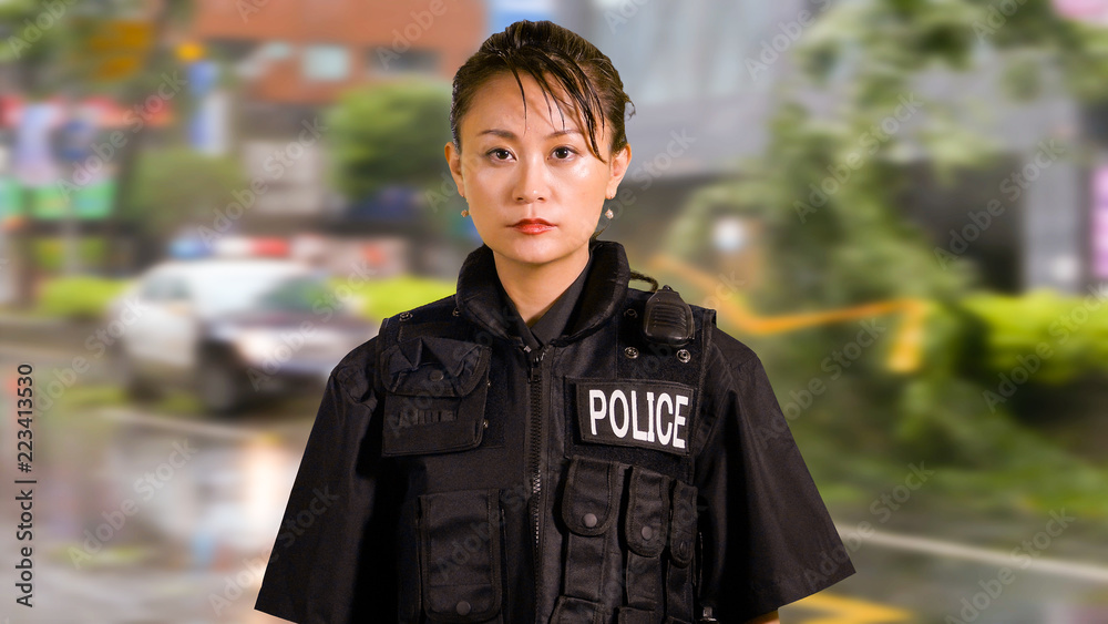 Enviromental portrait of Asian American Woman Police Officer at Crime ...