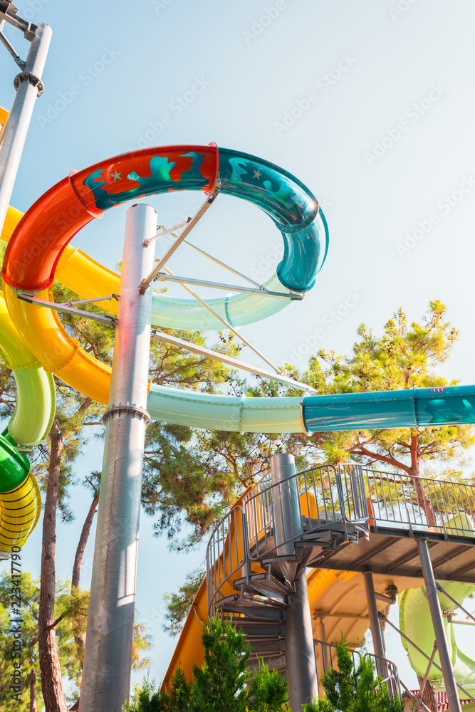 Vicky beautiful multi-colored water slide on the blue sky background ...