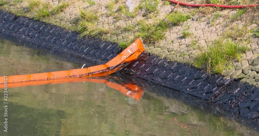 oil spill containment boom floating on water surface at oil ...