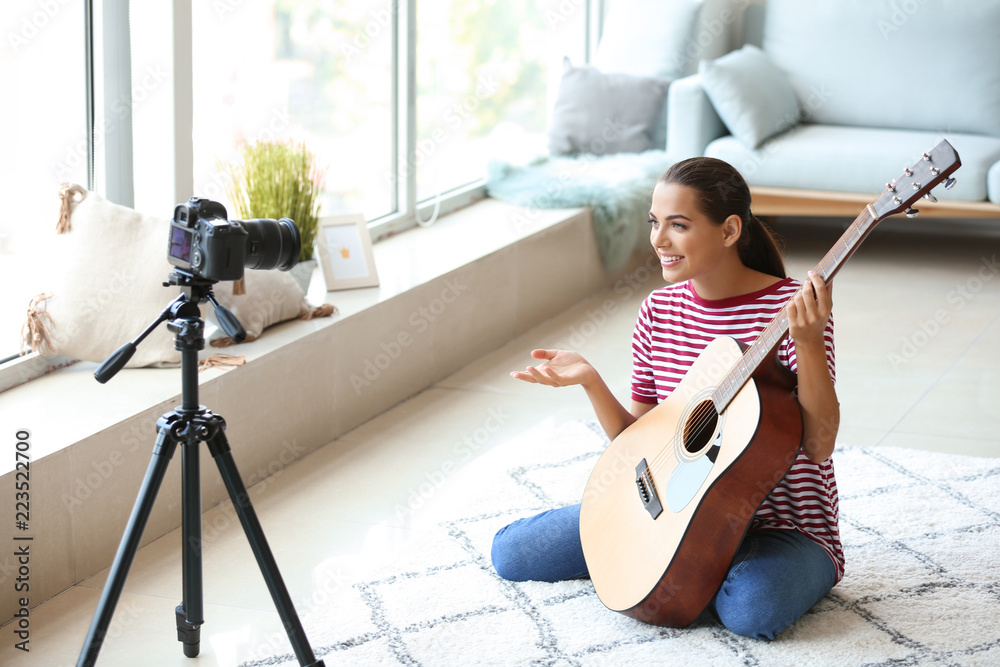 Young female musician recording video indoors Stock Photo | Adobe Stock
