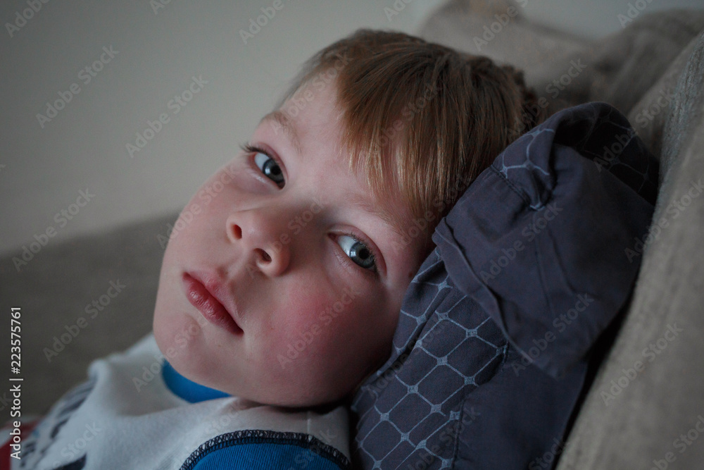 Ailing sad little boy with temperature and red cheeks in his bed Stock ...