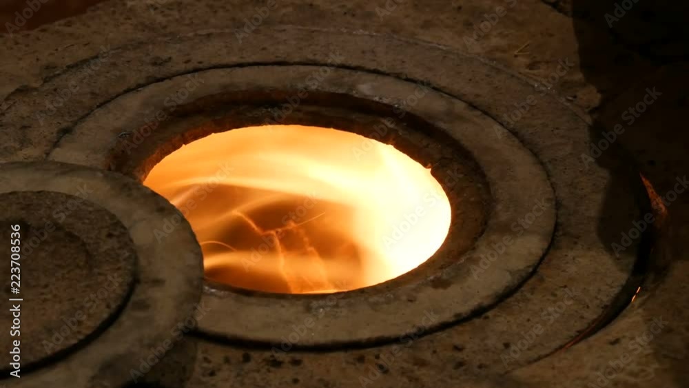 Very old brick oven with cast-iron pancakes, in which fire burns. A ...