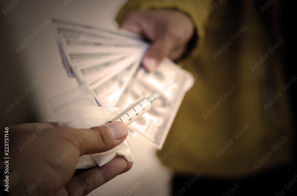Concept: the Asian men are buying-selling drugs with dollars ...