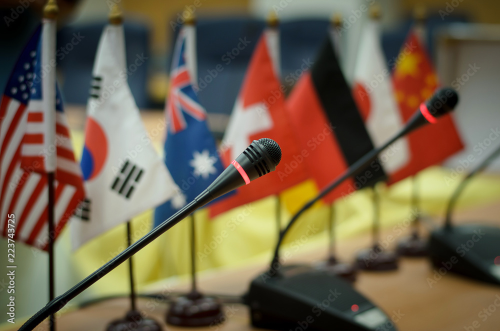 Microphone in a conference room, with flags of various countries Stock ...