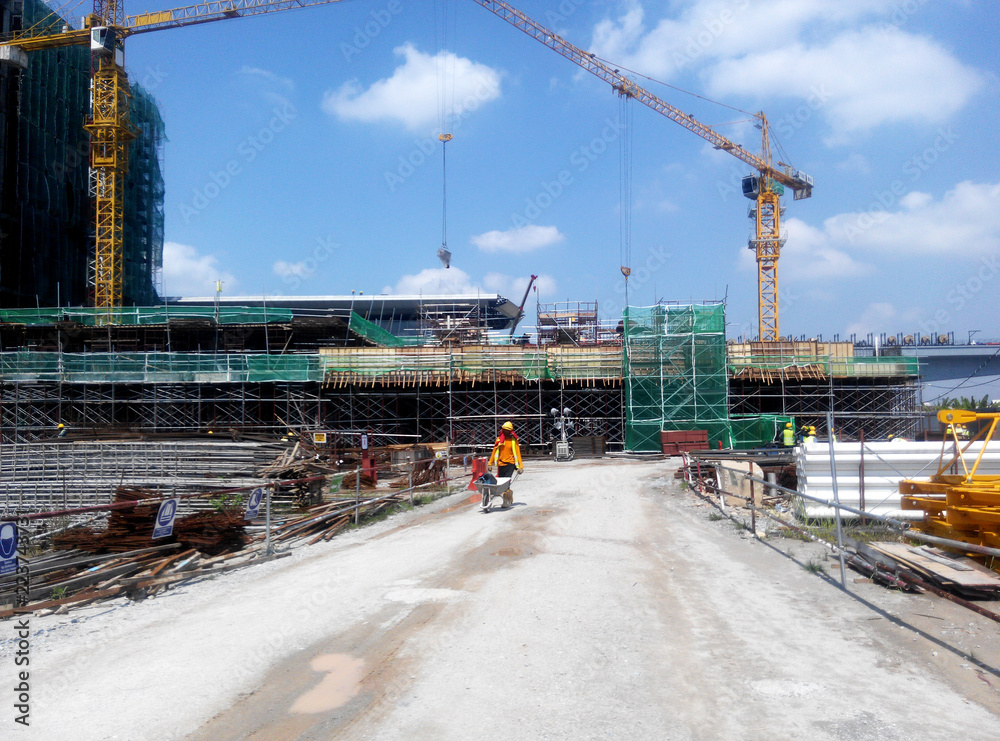 Group of construction workers working at construction site. Building ...