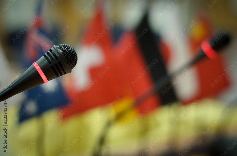 Microphone in a conference room, with flags of various countries Stock ...