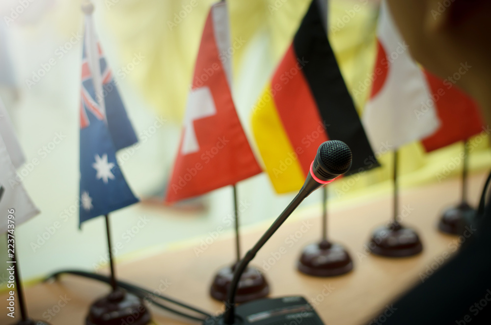 Microphone in a conference room, with flags of various countries Stock ...