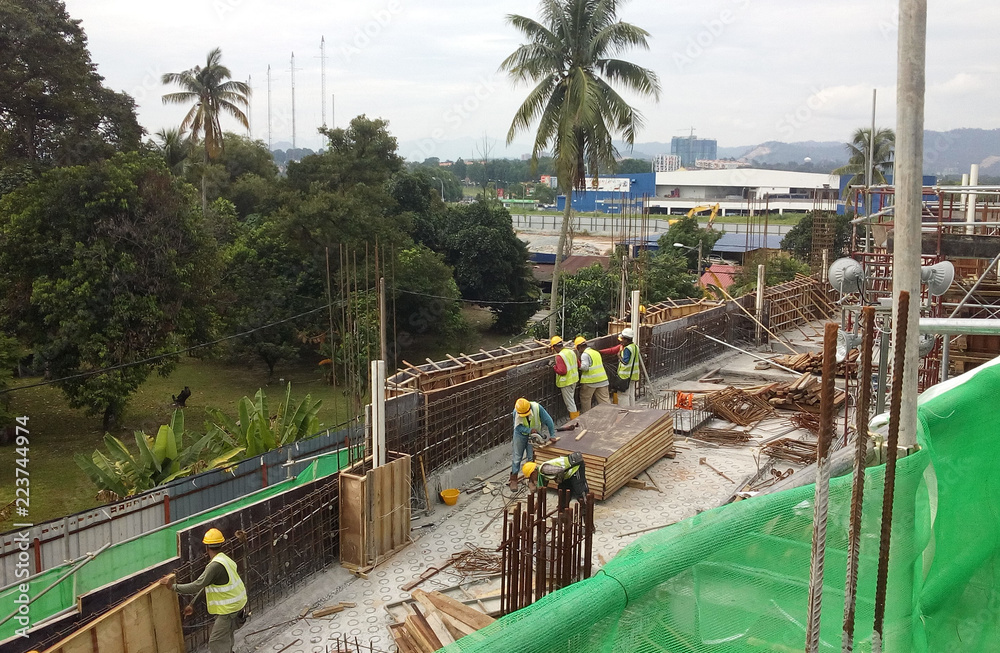Group of construction workers working at construction site. Building ...