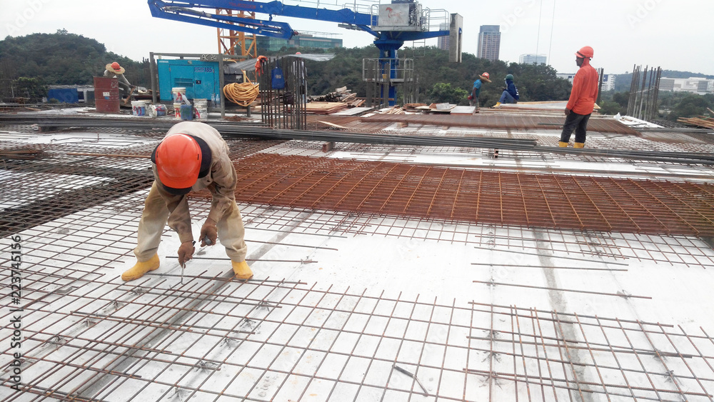 Group of construction workers working at construction site. Building ...
